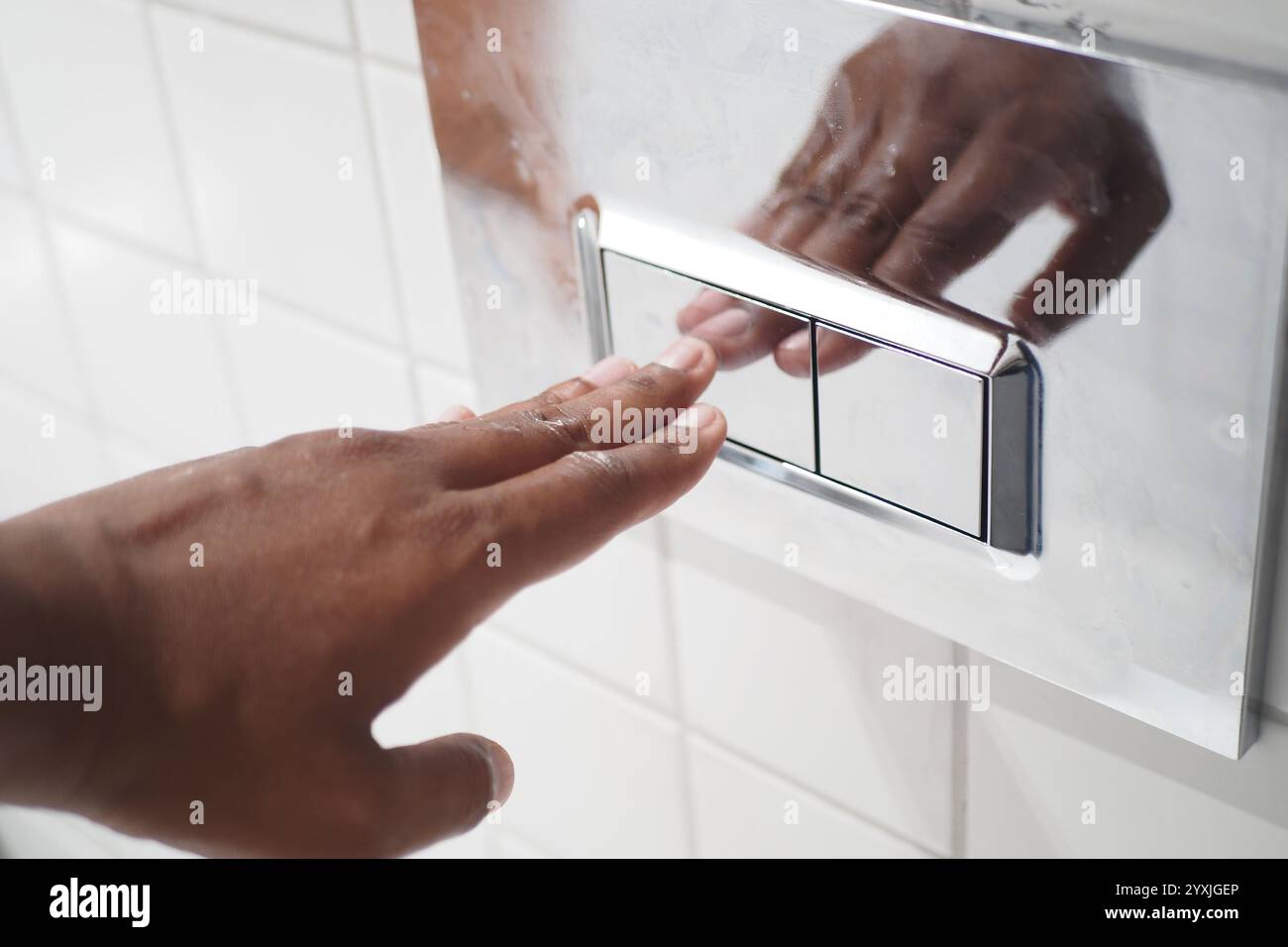 A modern bathroom with flush plate and herringbone tiles for a stylish ...