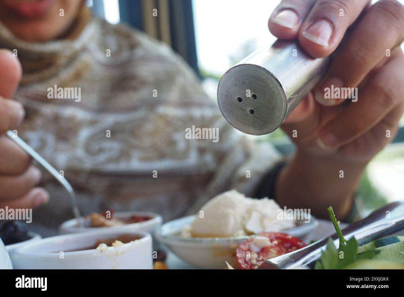 Salt falls from a salt shaker Stock Photo - Alamy