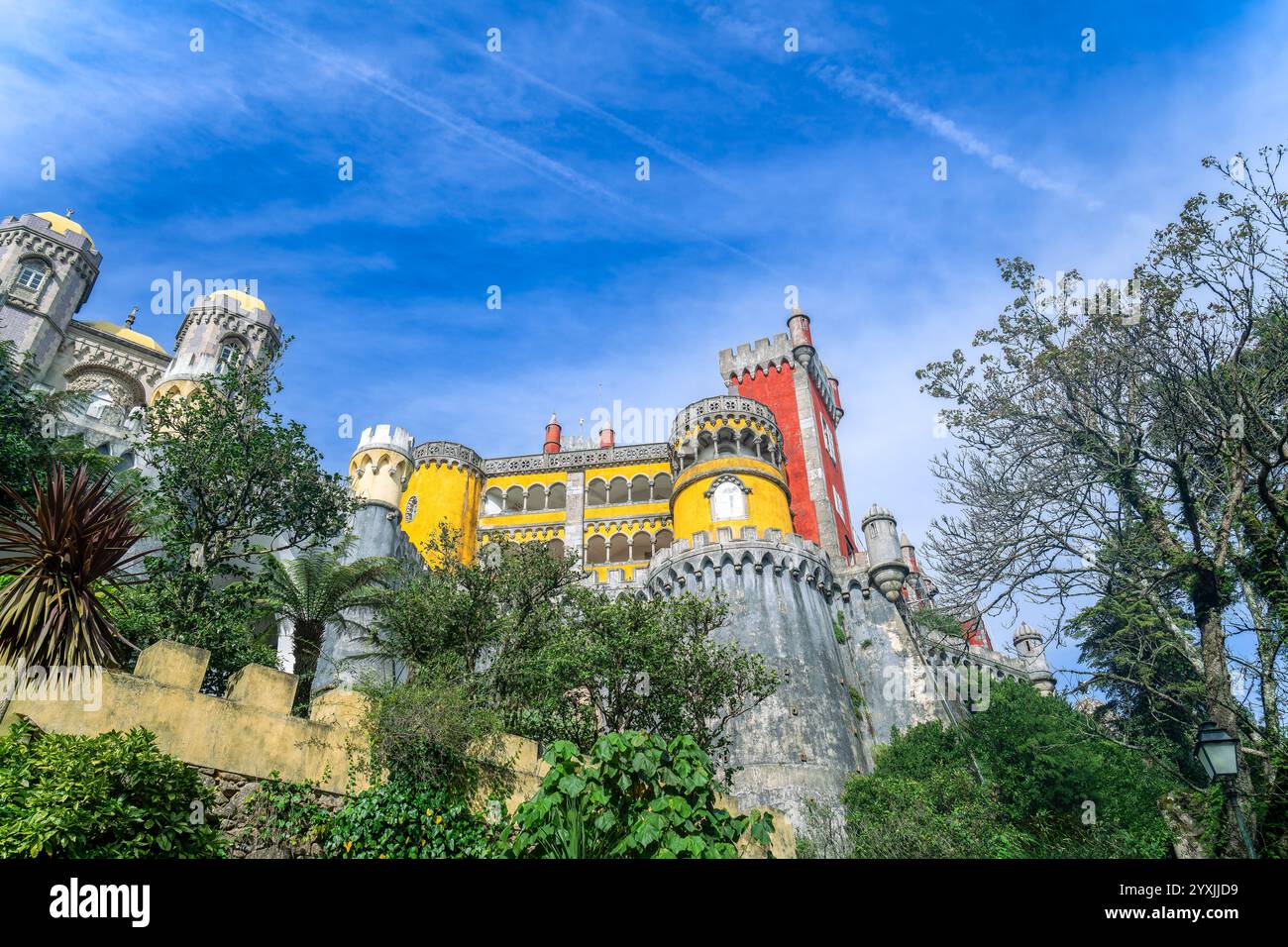 The Pena Palace showcases its vibrant yellow and red towers against a ...