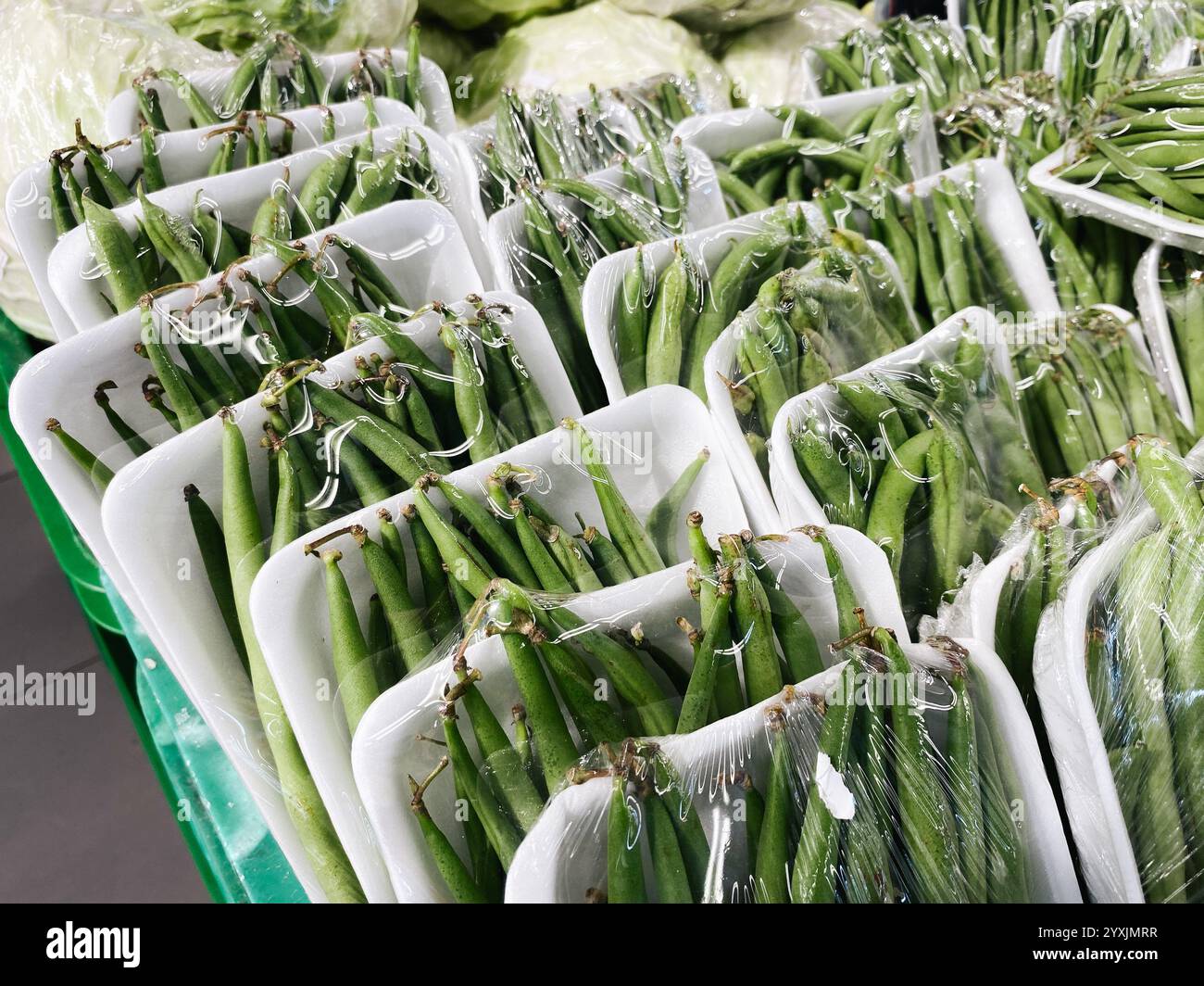Green beans packaged with styrofoam and plastic displayed in ...