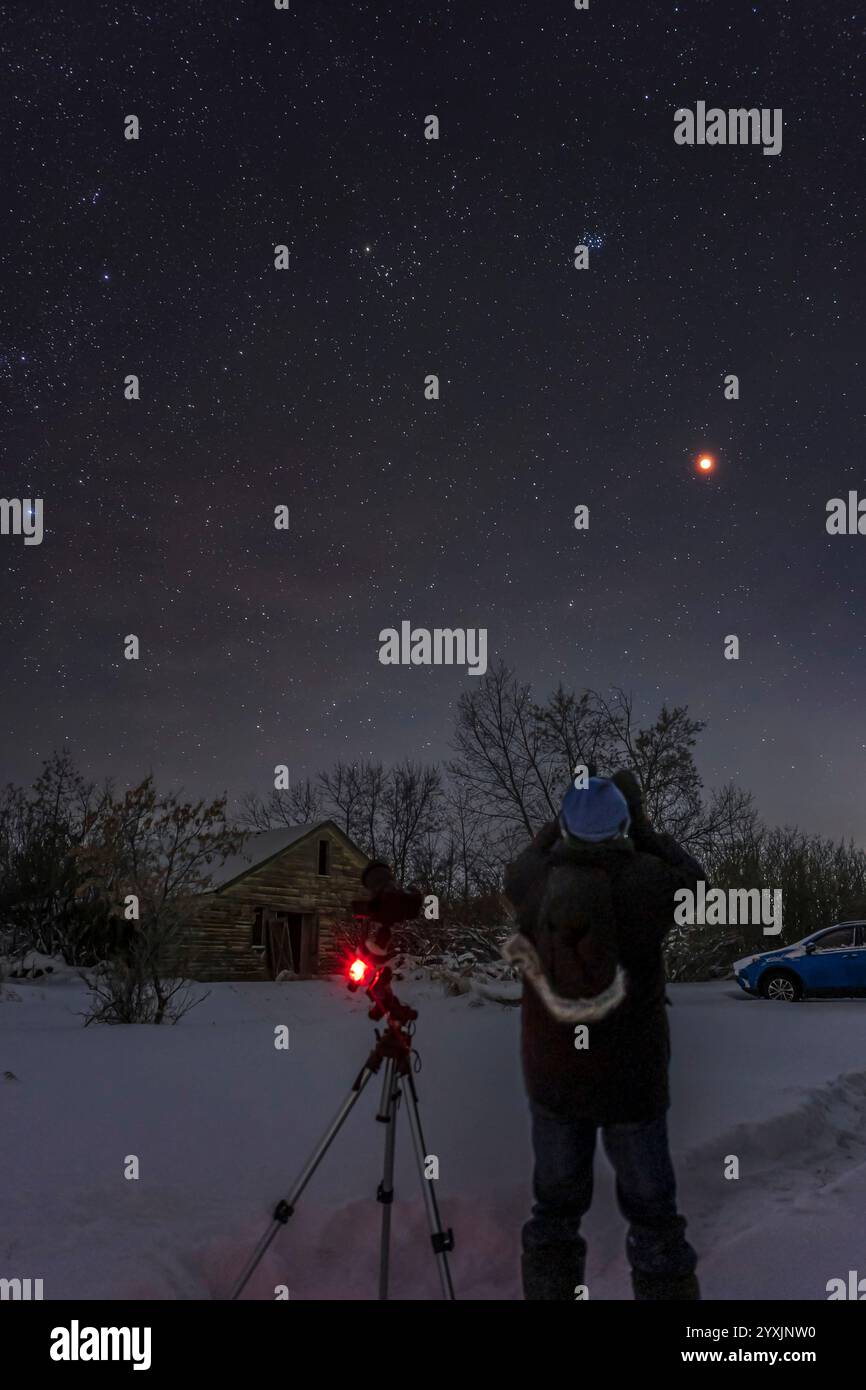 Astronomer observing the total eclipse of the Moon in Alberta, Canada ...
