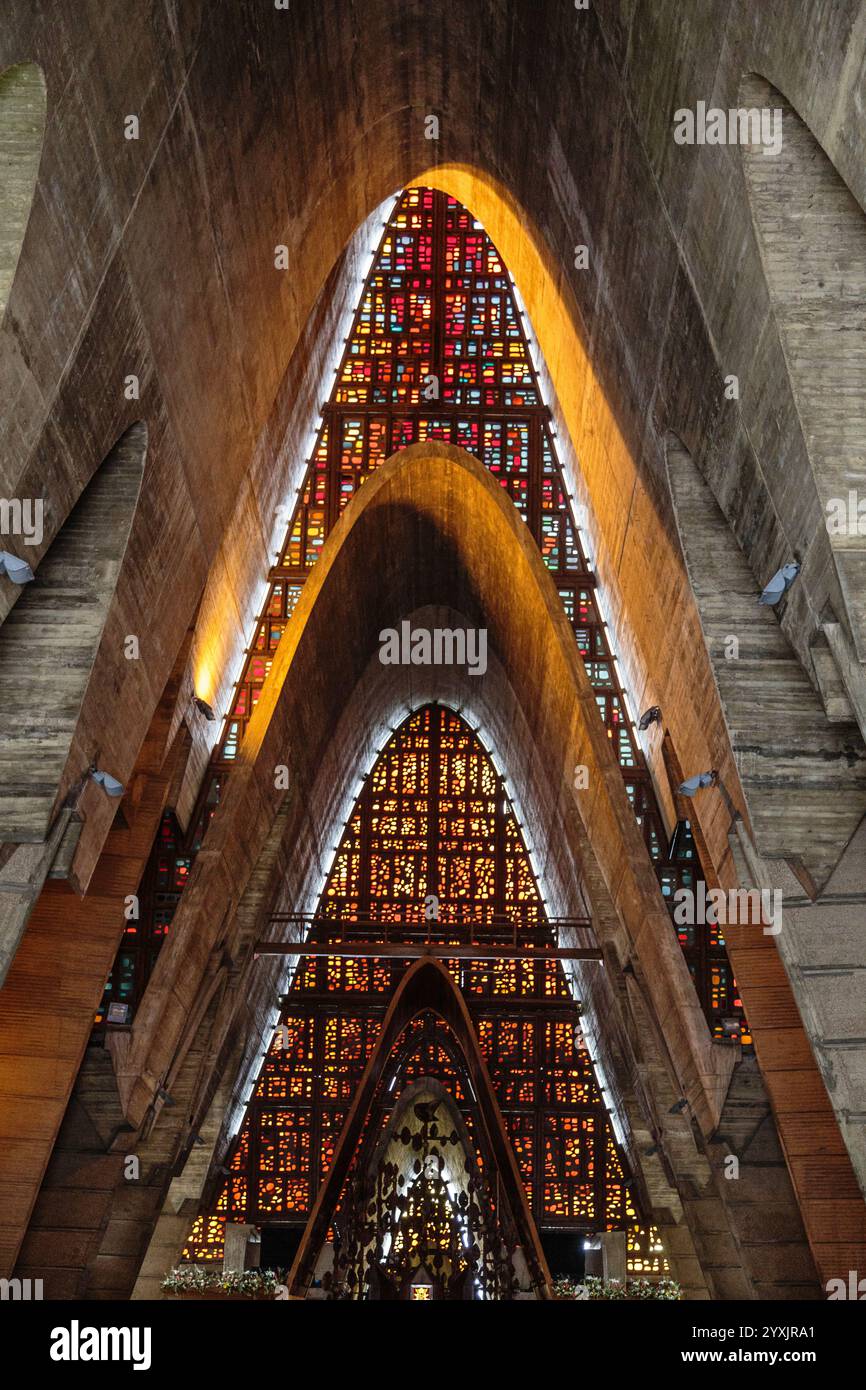 The inside of a church with a large archway and stained glass windows ...