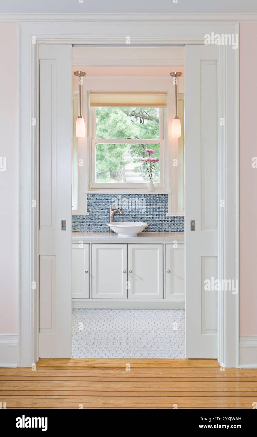 Entrance to pretty feminine bathroom with pink walls and blue mini-tile ...