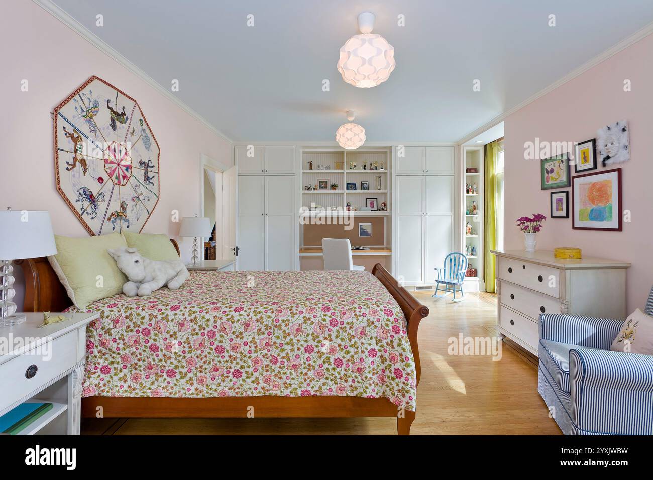 Girl's pink bedroom with built-in desk, cabinets and shelving Stock ...