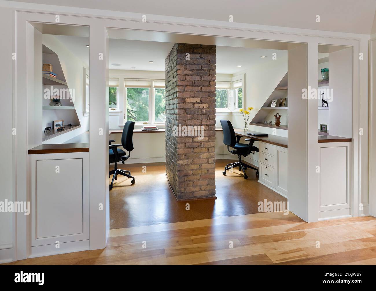 Very nice home office with two built-in desks and wood trim around ...