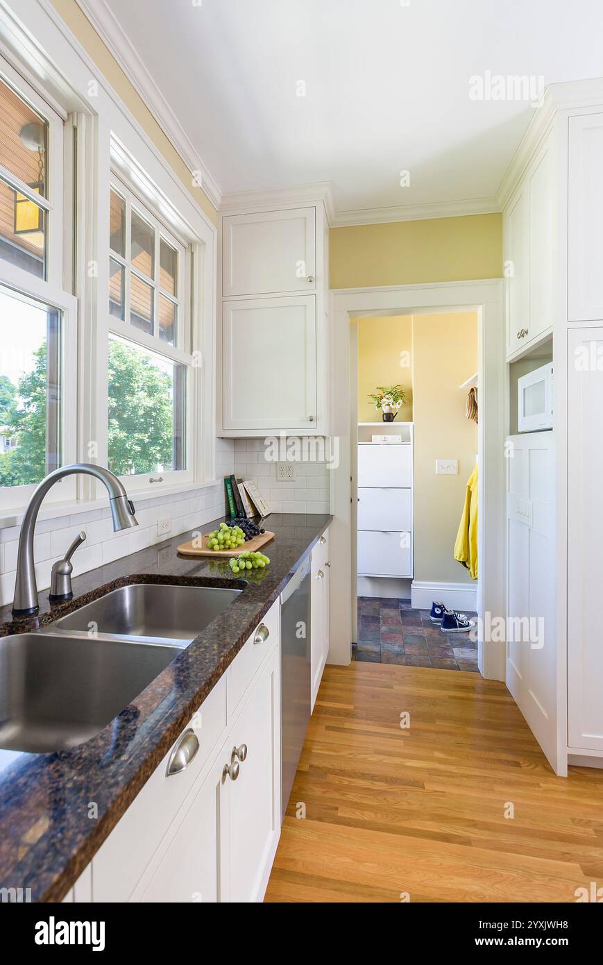 Contemporary white kitchen with view into back hallway/mudroom Stock ...