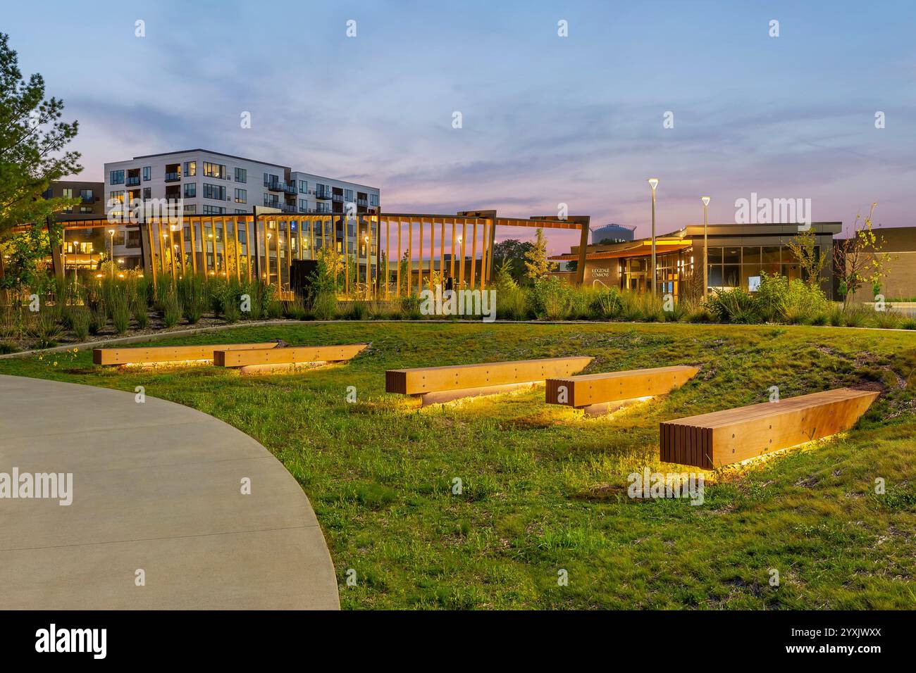 City park at dusk showing benches built into berm with indirect ...