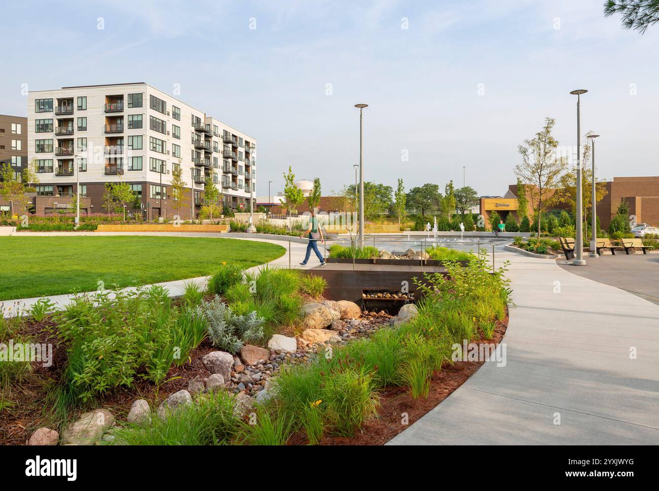 Dry stream with plantings and bridge that circulates water from ...