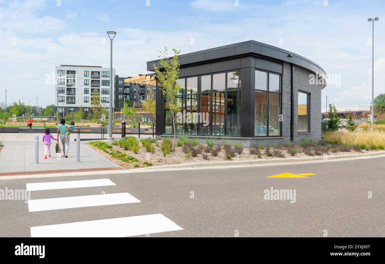 Side and back exterior of curving park building next to plaza built ...