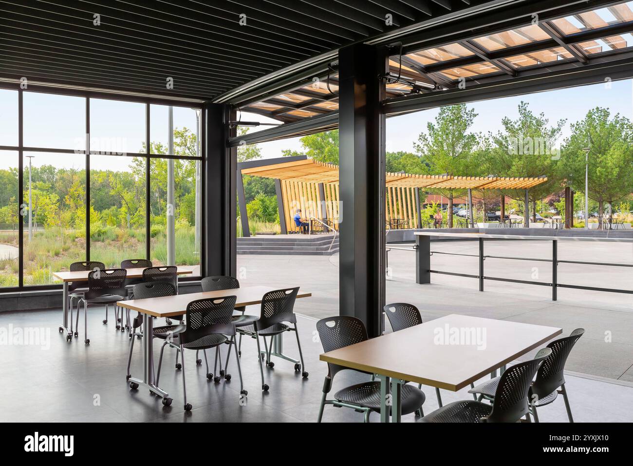 Looking out from interior of park building to round plaza and curved ...