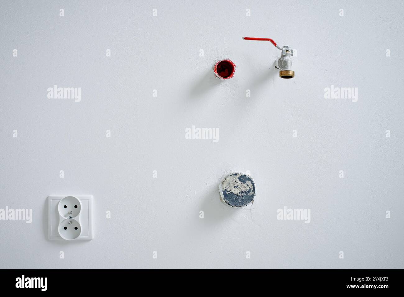 Water pipes and electrical outlets installed in new apartment during ...