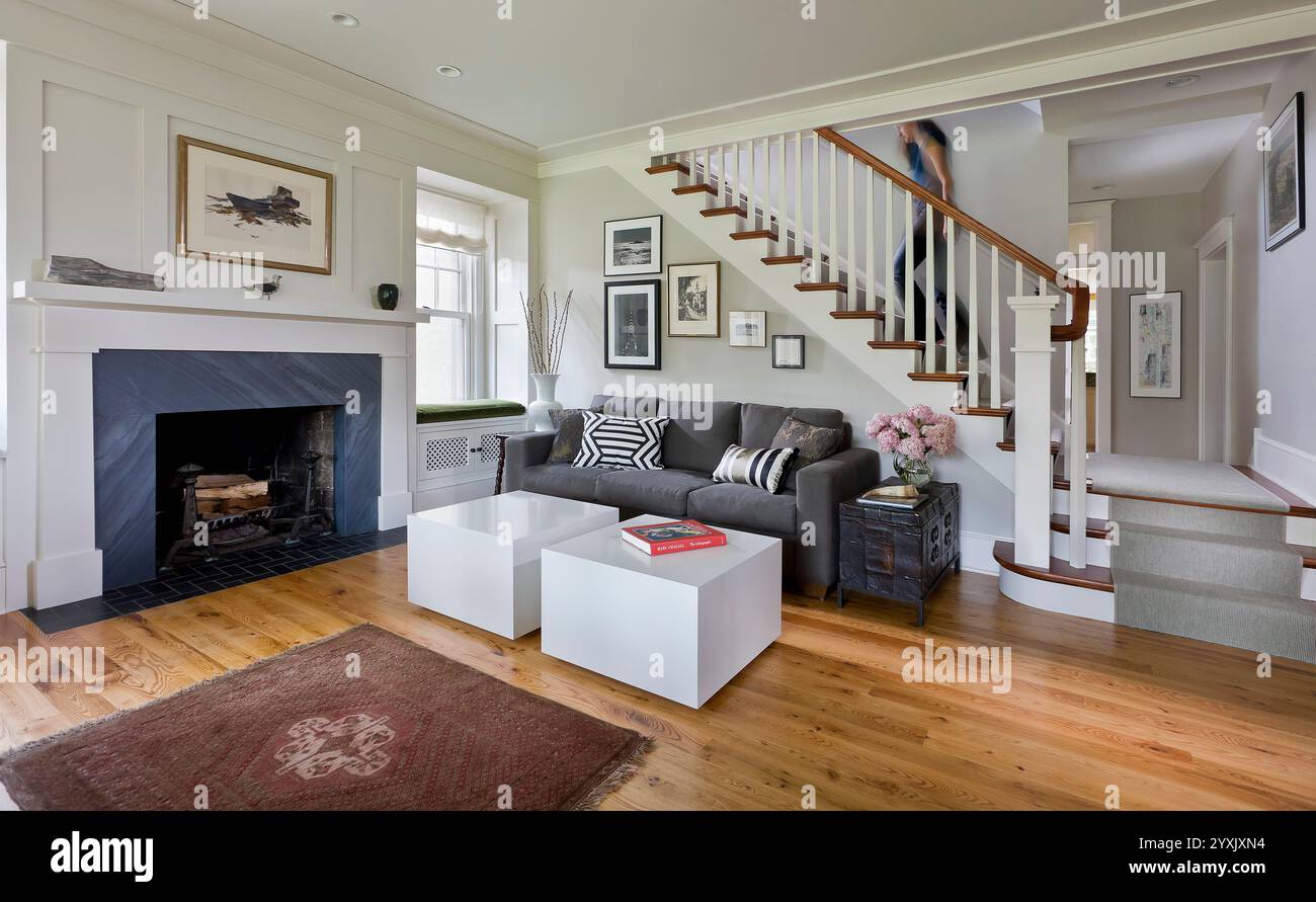 Corner of living room showing fireplace and framed art hanging above ...