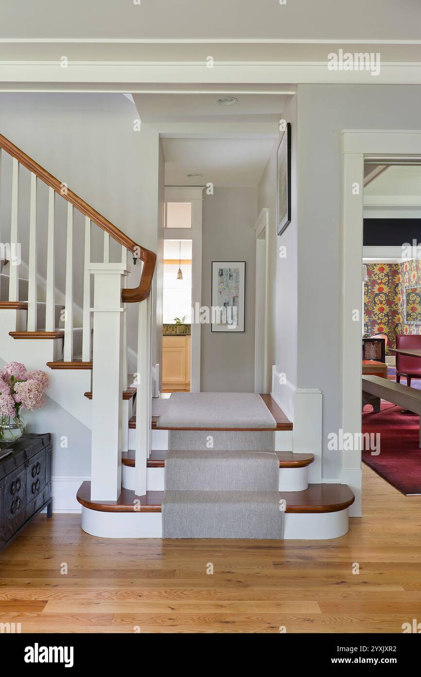 Landing of stairwell in home with stairs turning both directions Stock ...
