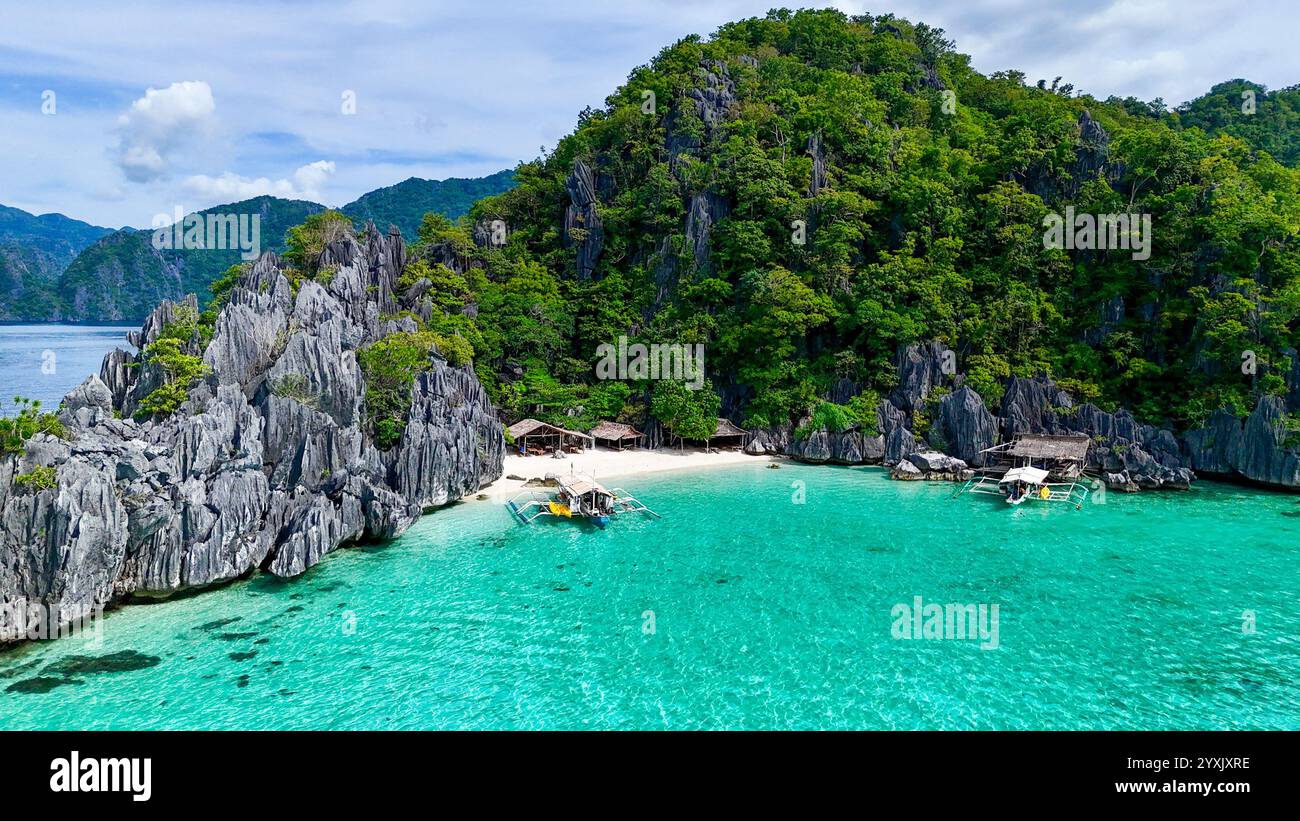 A breathtaking tropical beach surrounded by dramatic limestone cliffs ...