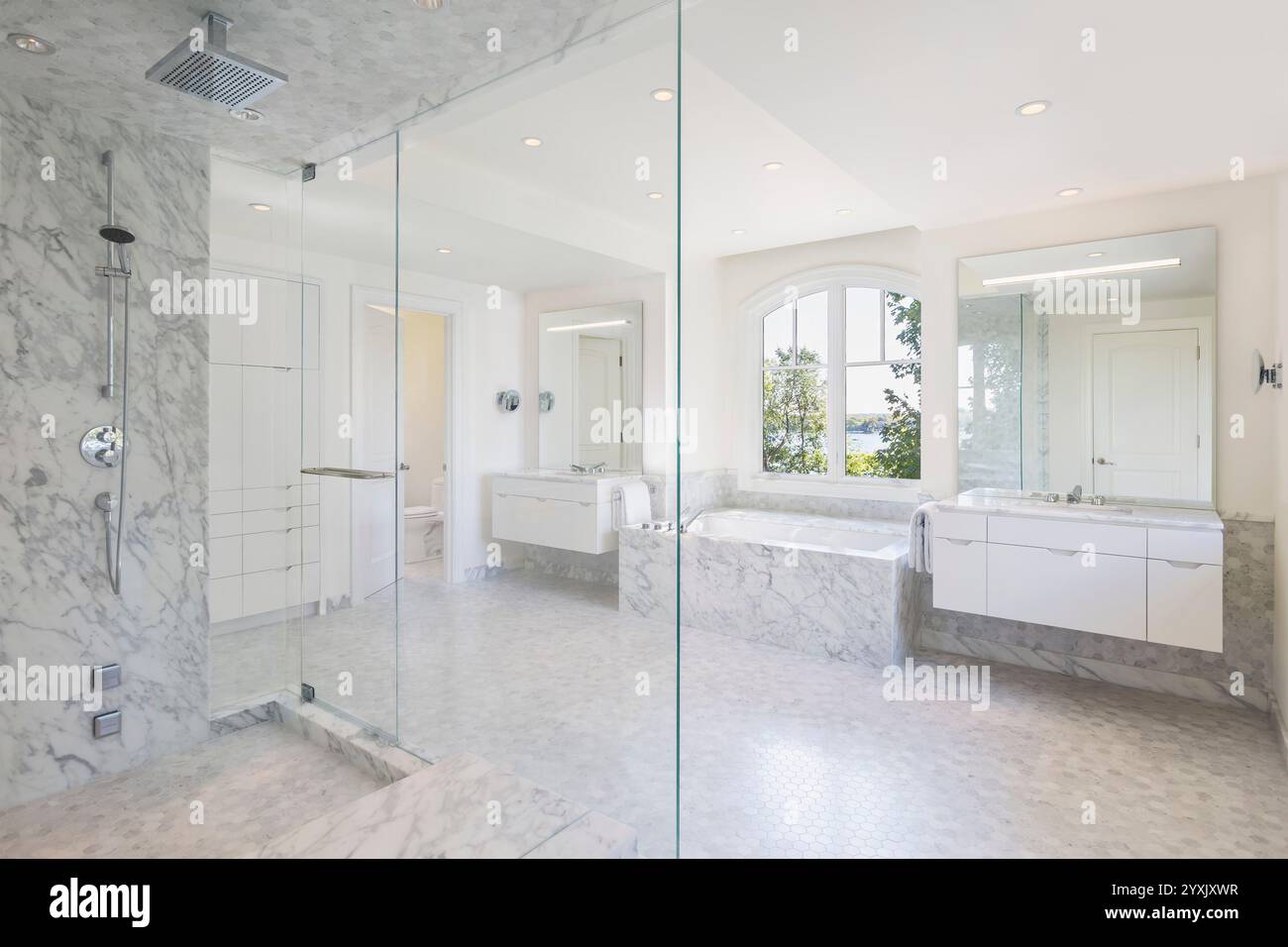 High end bathroom with Carrera marble floor and walls and tub surround ...