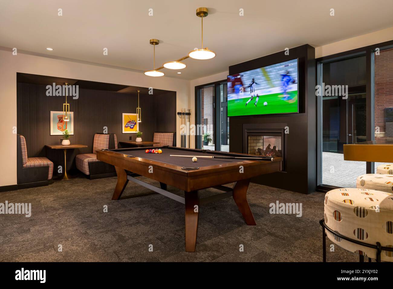 Billiards room at apartment complex with booth seating and large screen ...
