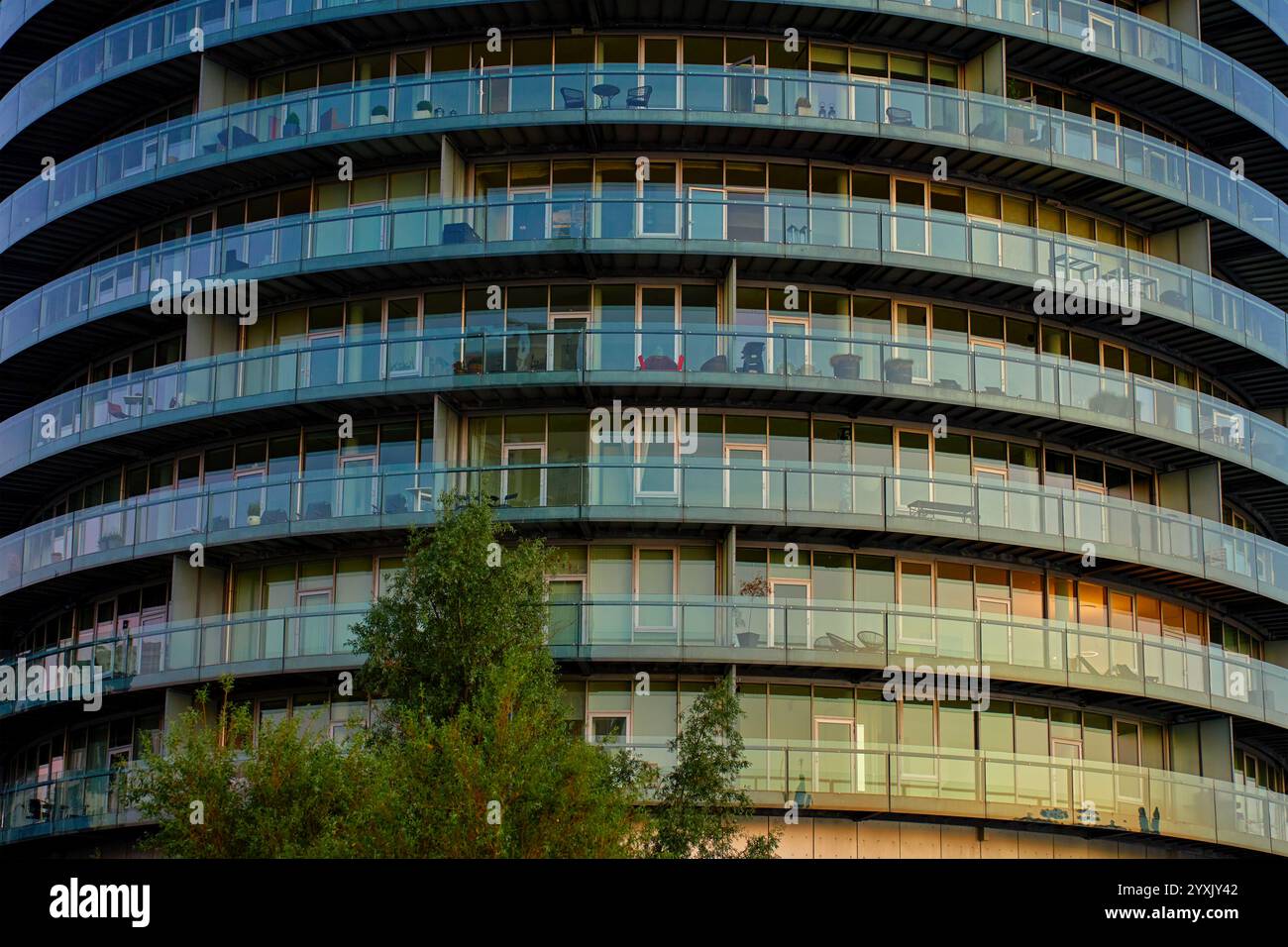 Modern round building with glass facade. Modern residential building ...