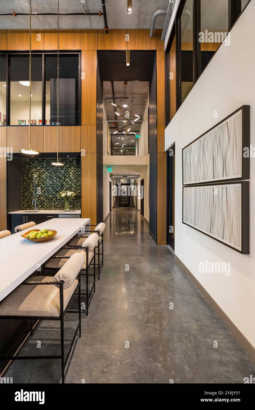 Two story lobby of apartment building with view down hallway hi-res ...