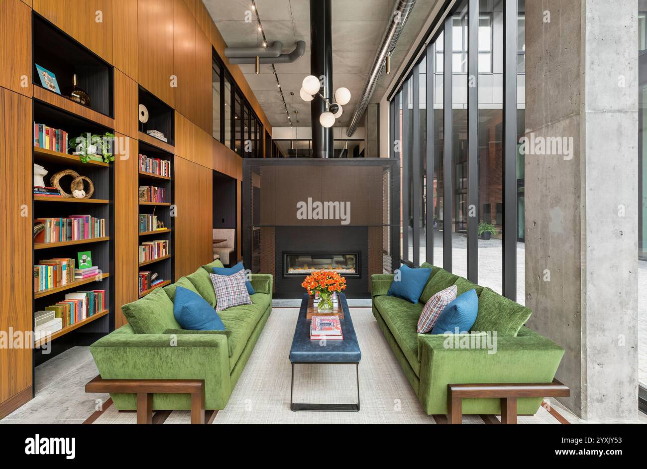 Tall two story lobby of apartment building with living room area and ...