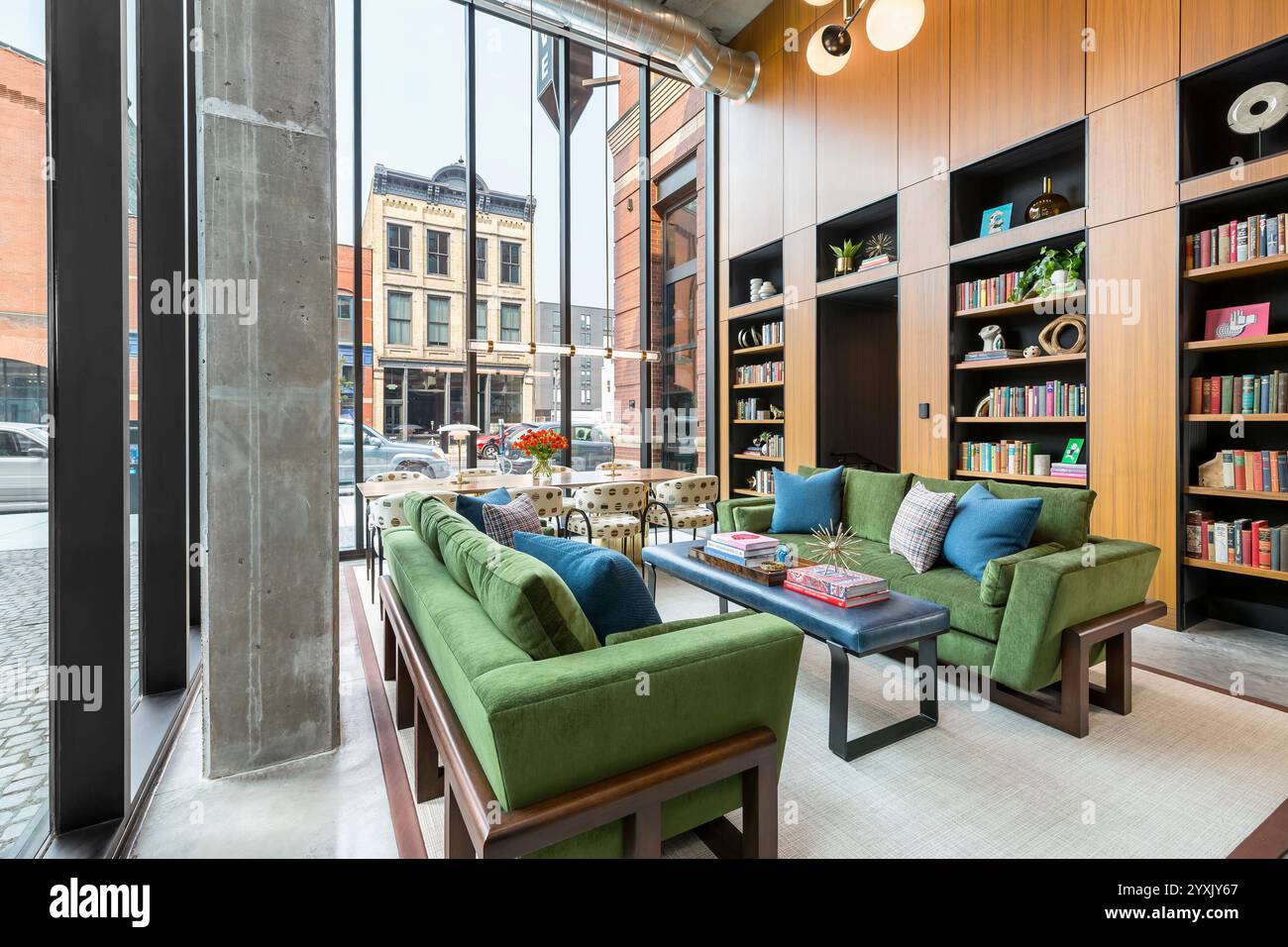 Tall two story lobby of apartment building with living room area and ...