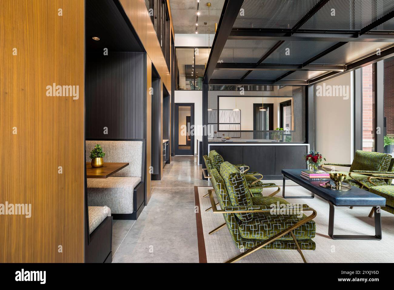 Two story lobby of apartment building with seating area under black ...