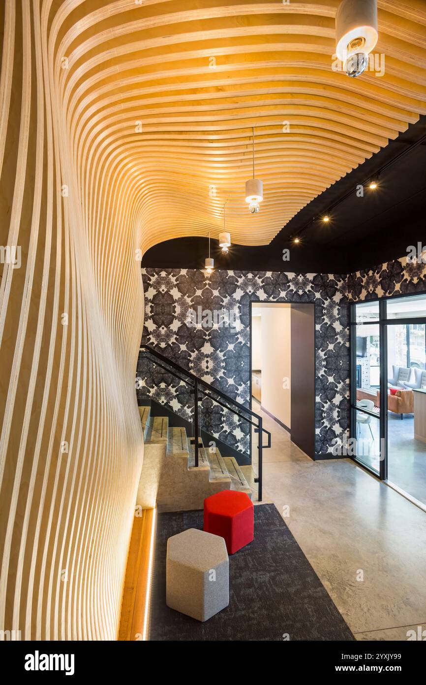 View of curving wood wall in entrance lobby to new apartment building ...