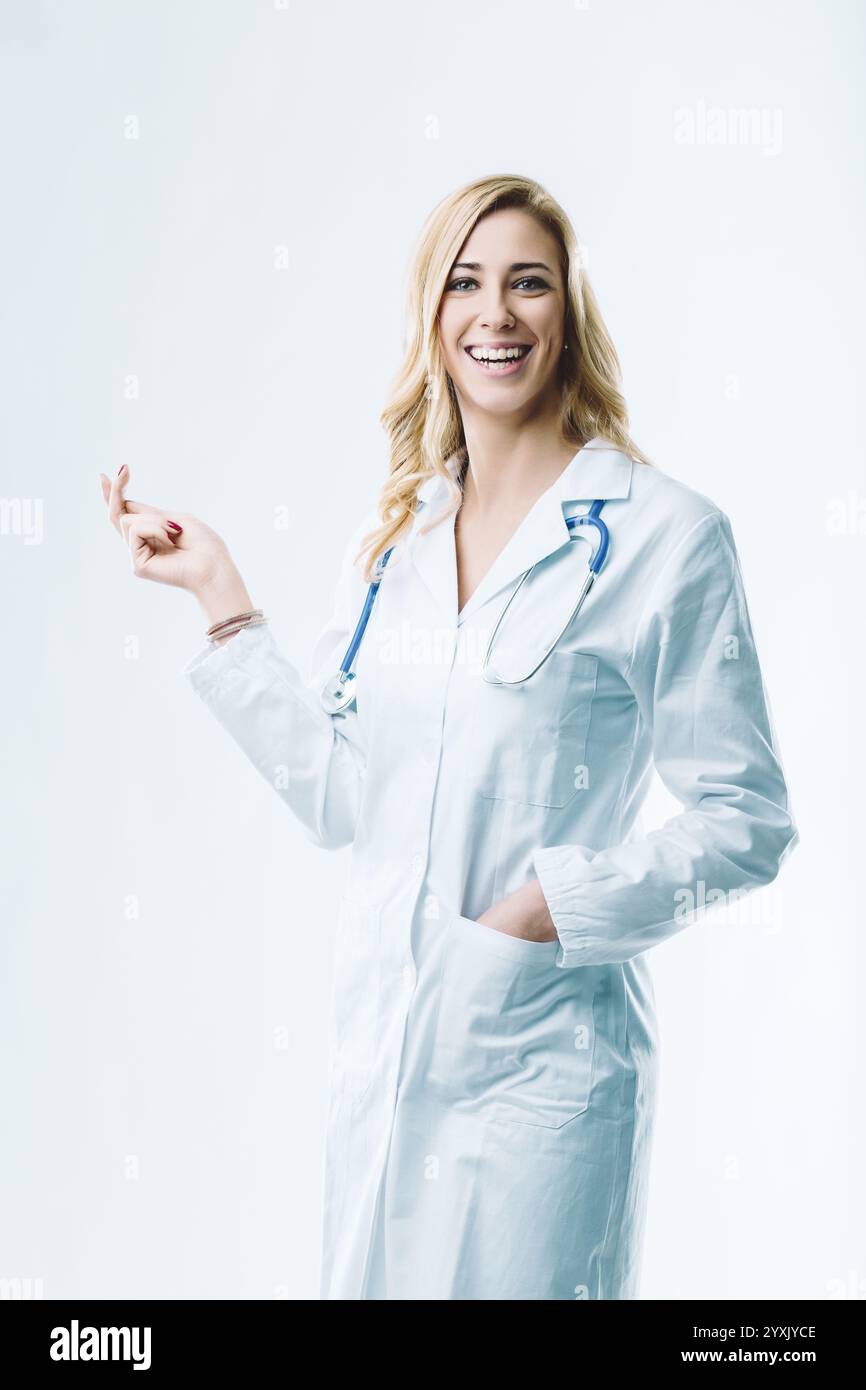 Young Female Doctor Smiling And Showing Something Imagining The Future young-female-doctor-smiling-and-showing-something-imagining-the-future