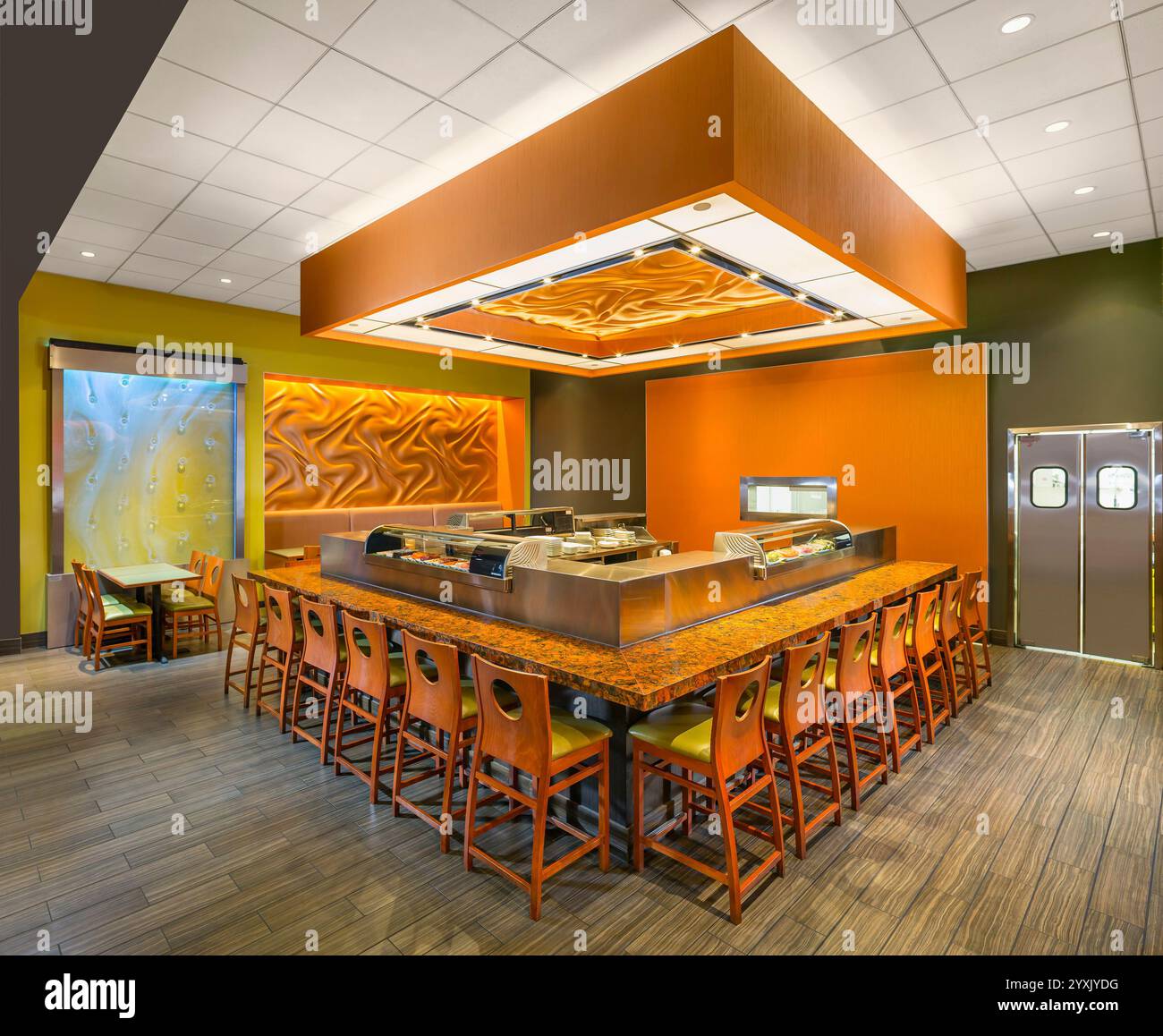 Sushi restaurant with large square sushi bar Stock Photo - Alamy