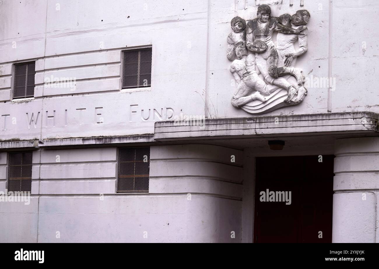 A Football Player Sculpture Is Shown On The Vintage Facade Of White A Football Player Sculpture Is Shown On The Vintage Facade Of White
