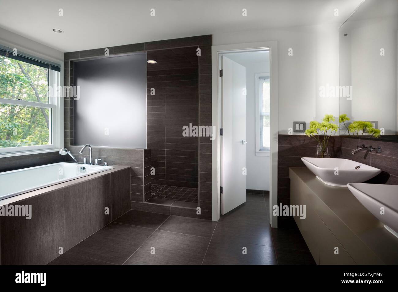 Modern bathroom with large gray tiled floor, bathtub platform and walk ...