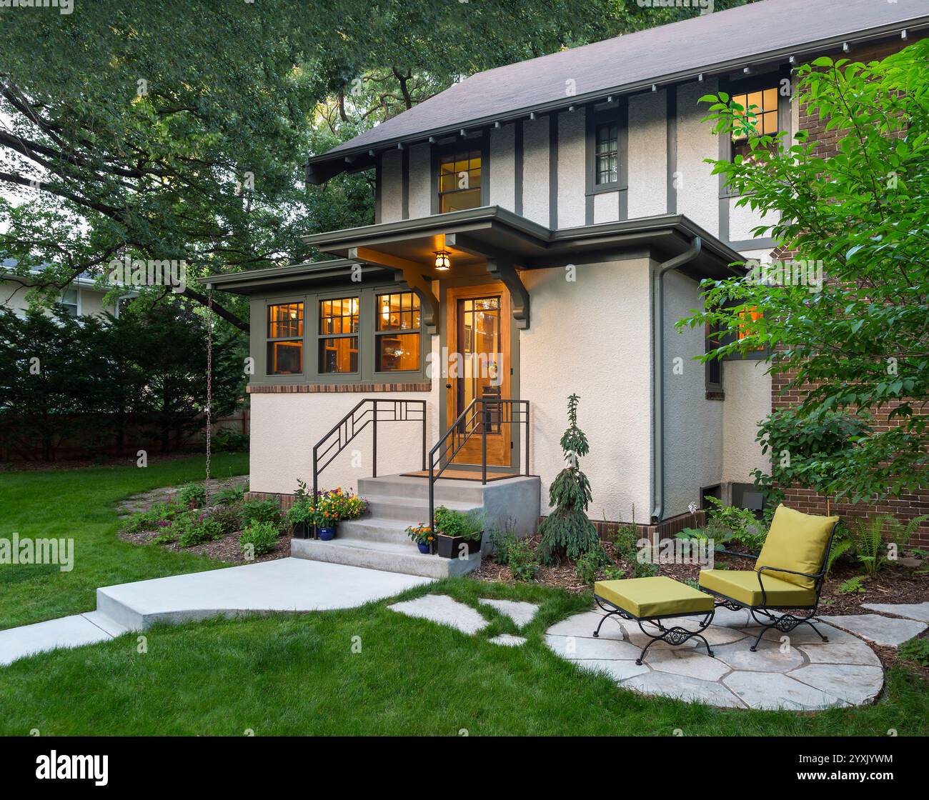 Remodeled back of older house with new back door and small sitting area ...