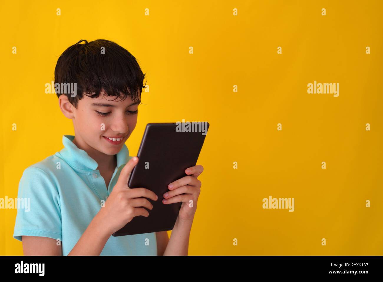 elementary school child smiling while looking at his tablet. video ...