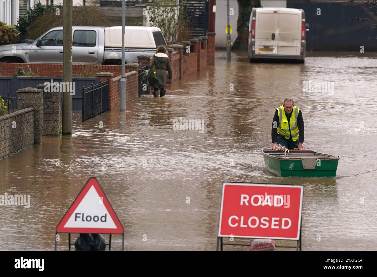 File photo dated 08/12/24 of a flood warden pushes a boat in floodwater ...