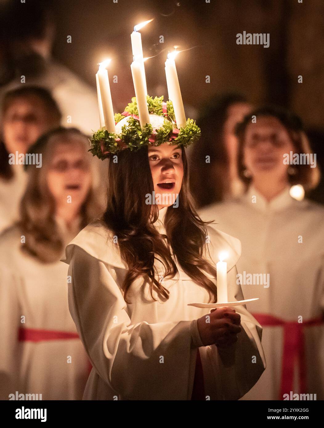 Alida Freding wears a crown of candles symbolising St Lucy as she leads ...