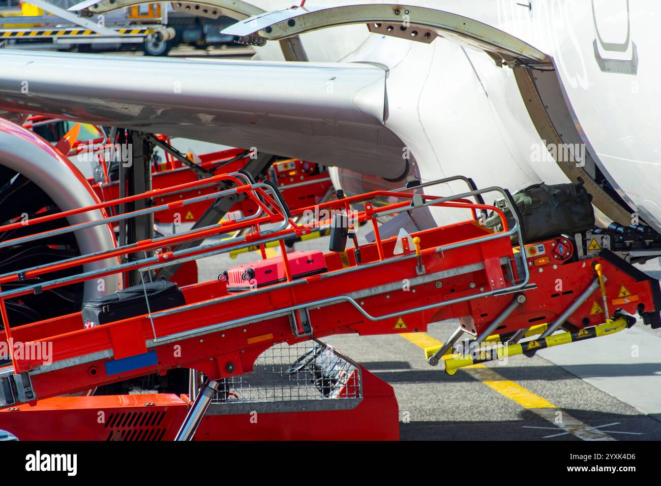 Baggage Unloading from Commercial Airplane Stock Photo - Alamy