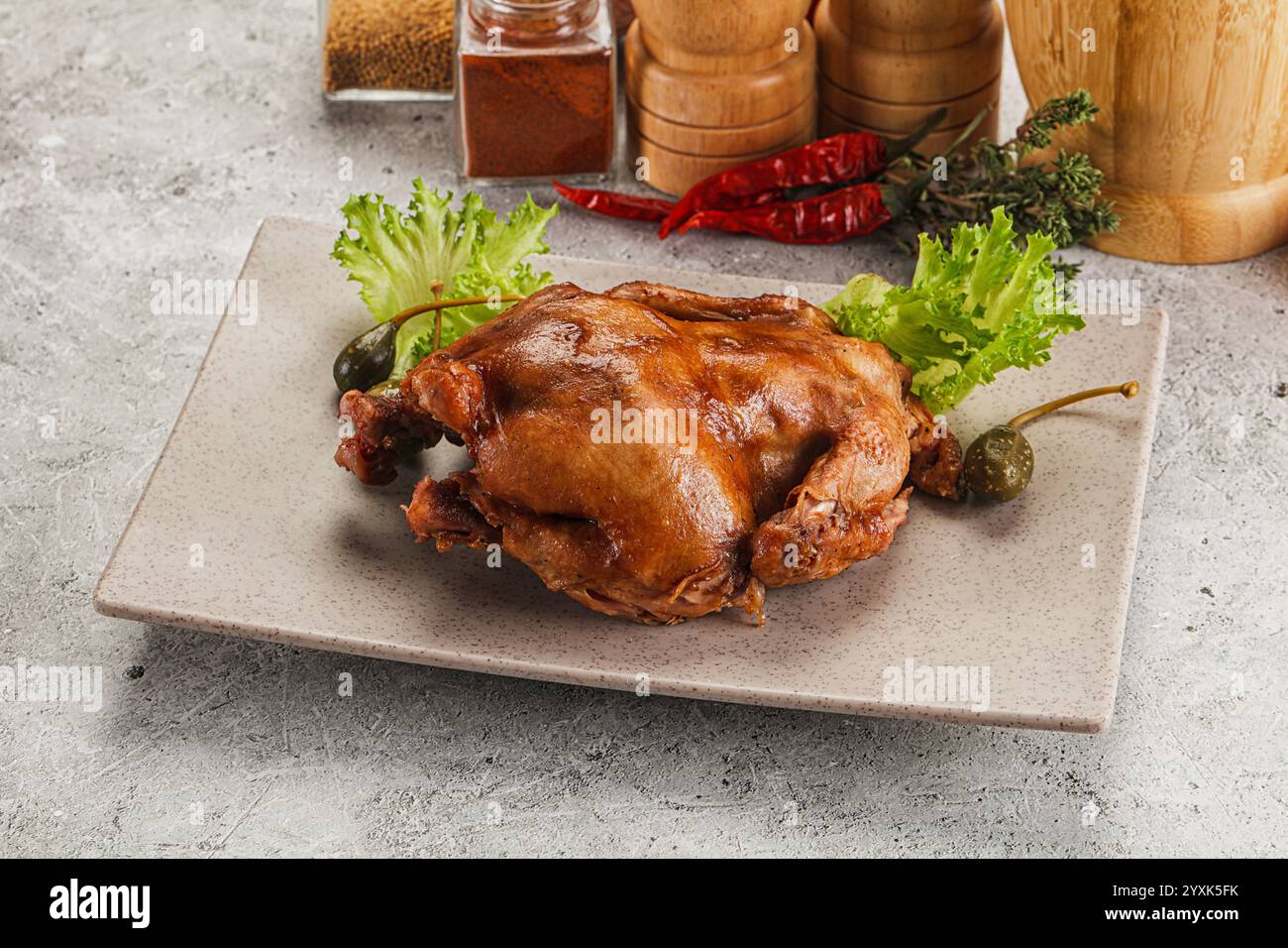 Baked whole small chicken with spices Stock Photo - Alamy