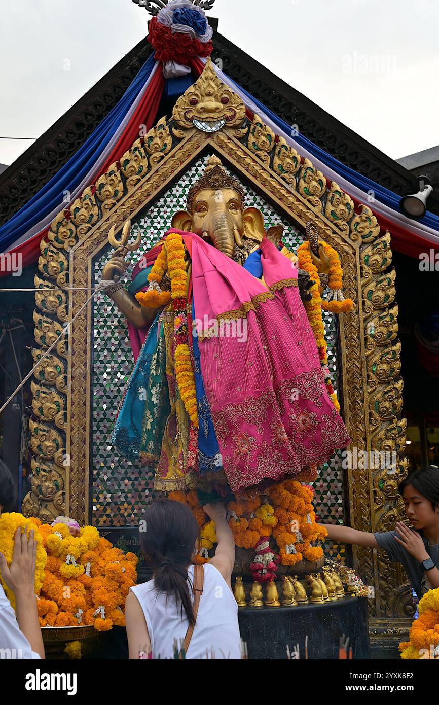 Devotees placing garland offerings at the highly revered Ganesha shrine ...
