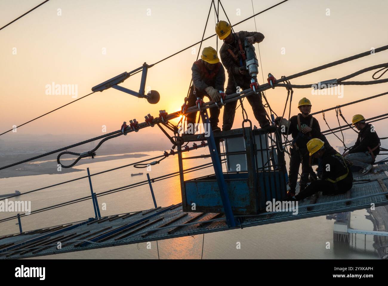 Huanggang. 16th Dec, 2024. An aerial drone photo taken on Dec. 16, 2024 shows builders working ...