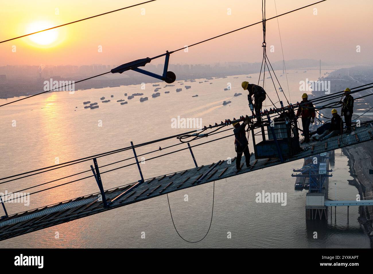 Huanggang. 16th Dec, 2024. An aerial drone photo taken on Dec. 16, 2024 shows builders working ...