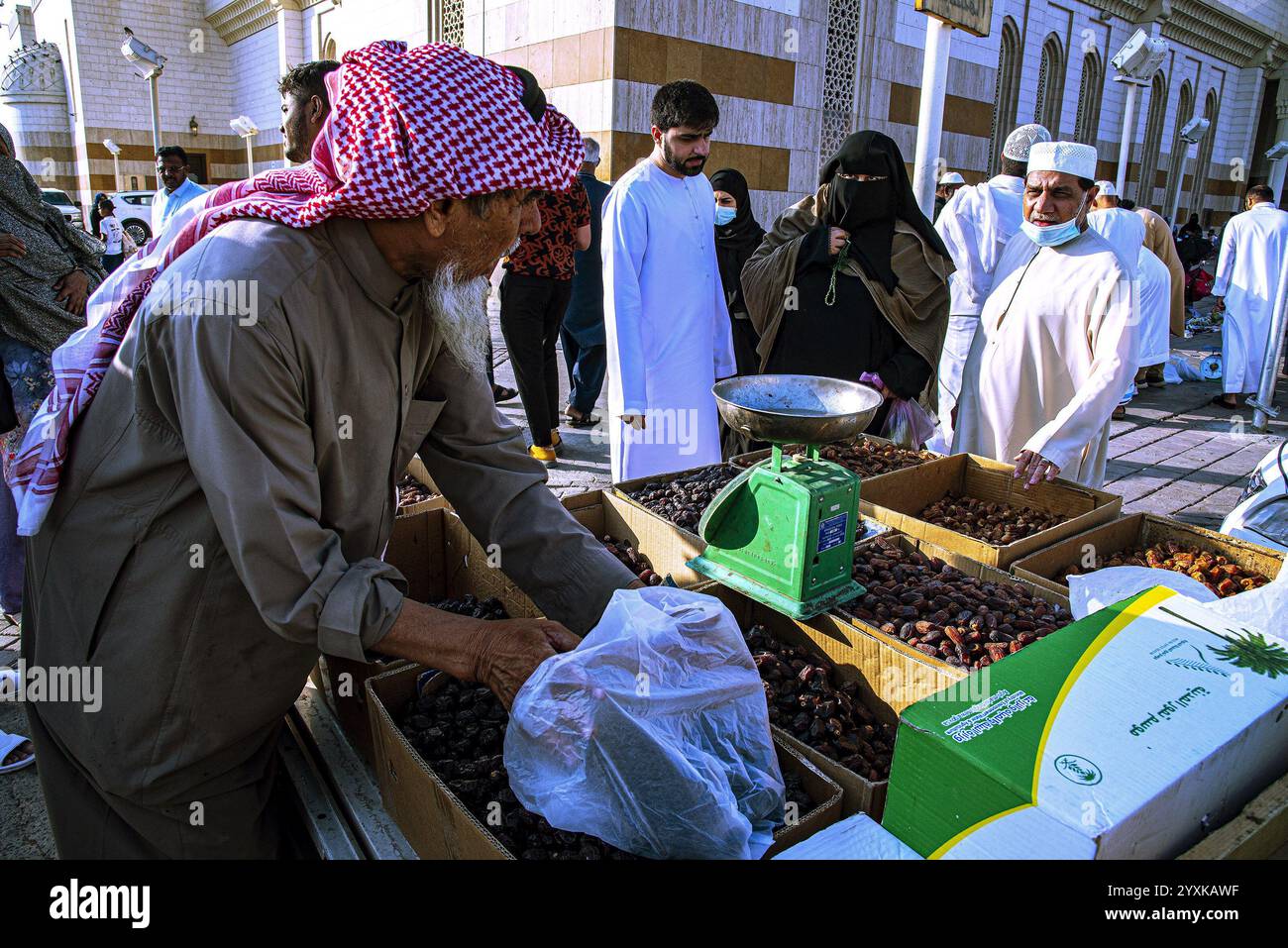 Saudi Arabia, Medina, 18-11-2024, date seller with customers at a ...