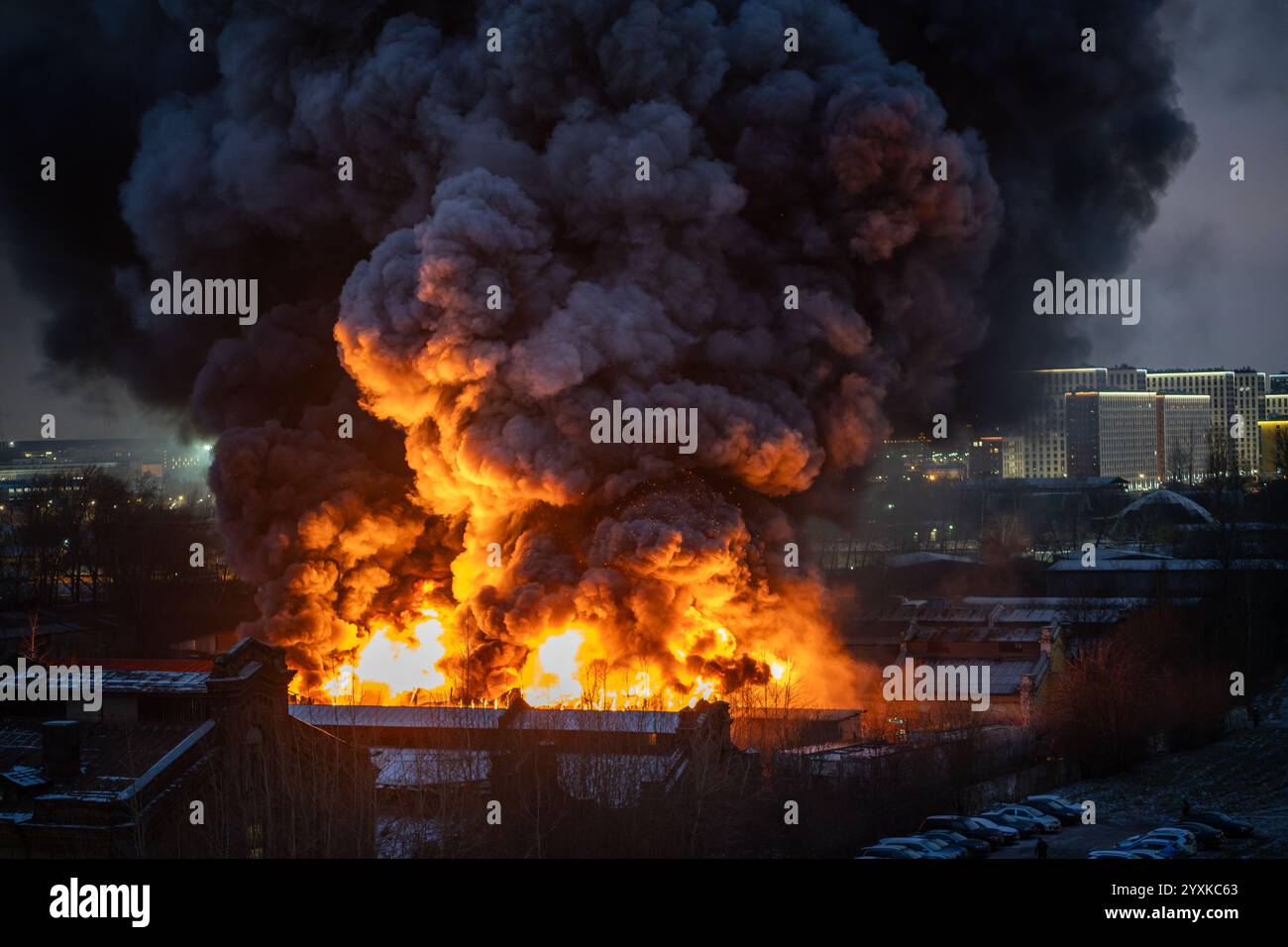 Heavy fire with acrid smoke in warehouse with toxic paint materials ...