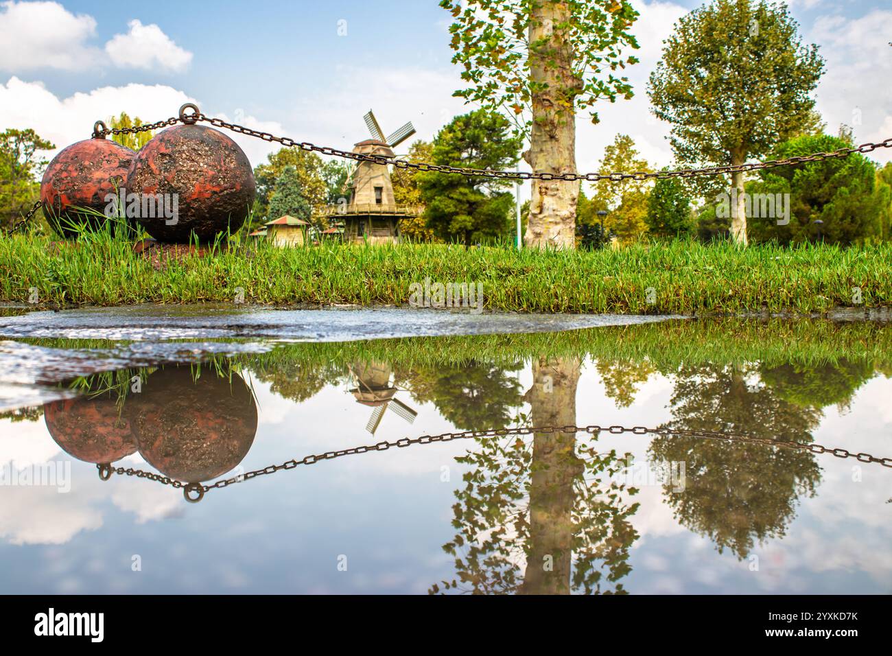 A vibrant summer view of Sakarya City Park with a windmill and water ...