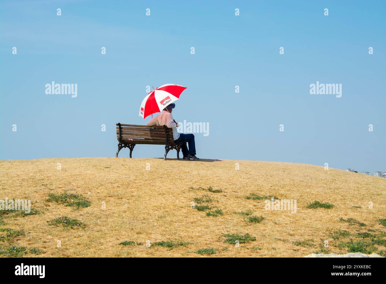 BELGRADE, SERBIA - AUGUST 18. 2024: Old man sitting on the bench with a ...