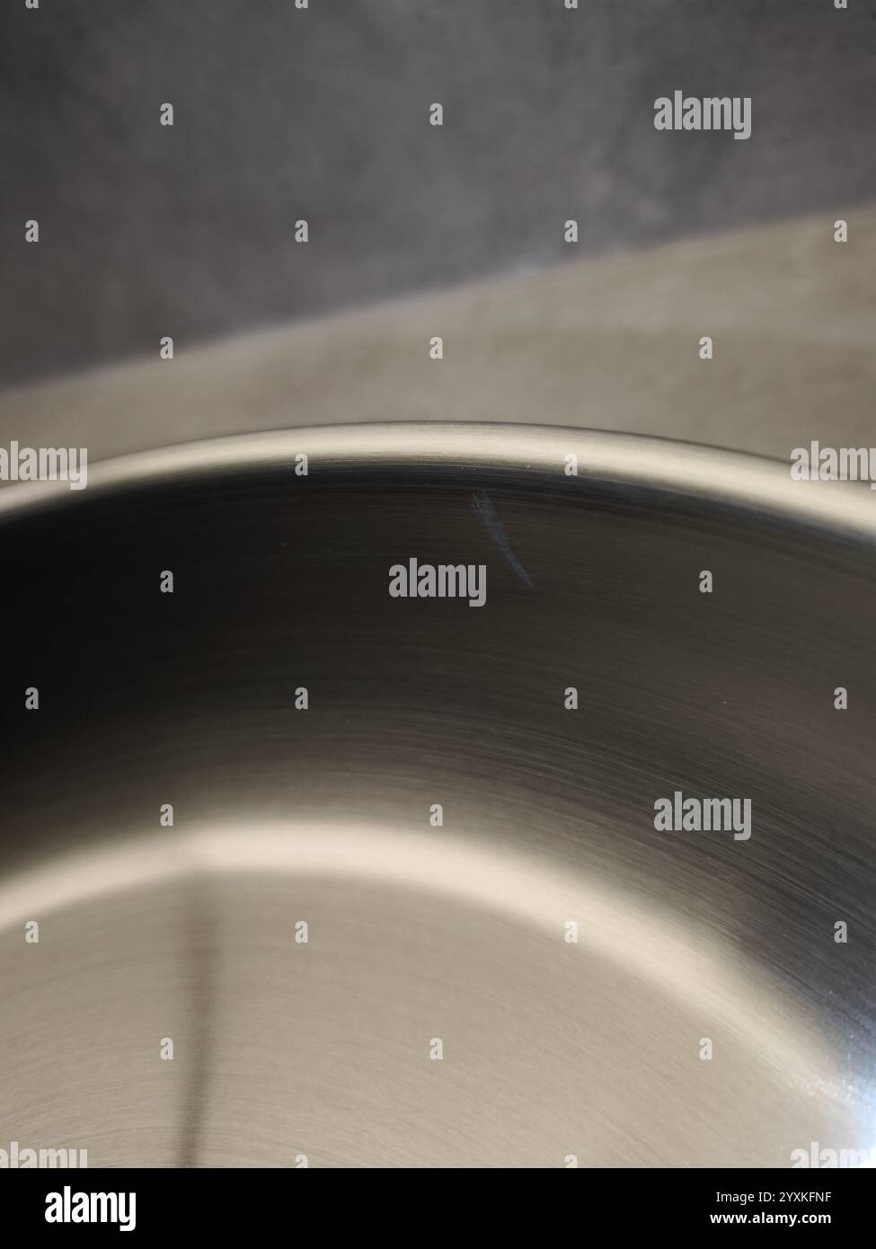 Stainless steel frying pan is waiting on a kitchen countertop, ready to ...