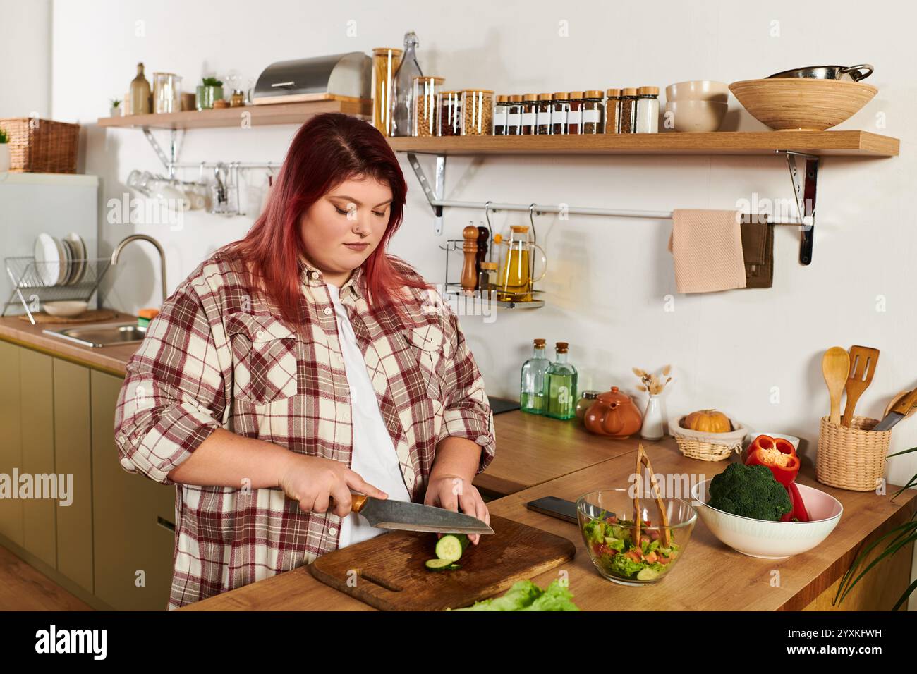 Plus size woman skillfully chops vegetables, creating a delightful meal ...