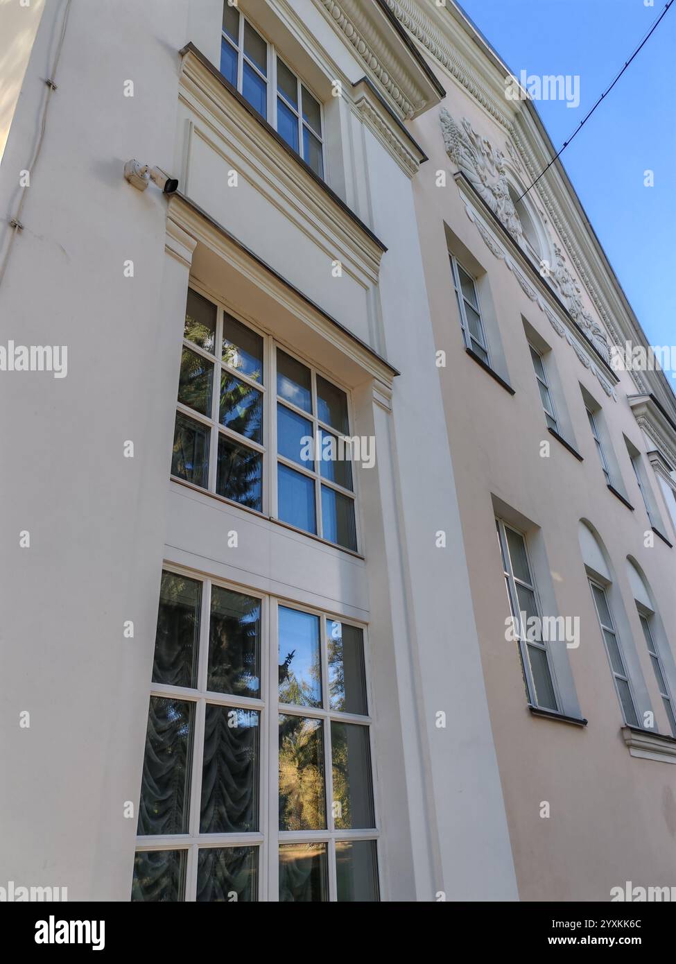 A detailed view of a classical building with clean lines, symmetrical ...