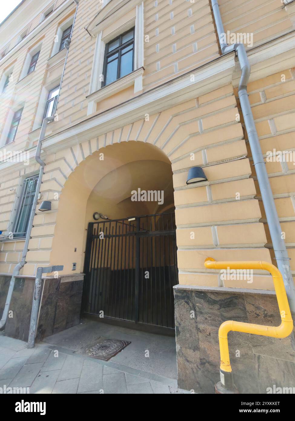 A beige neoclassical building facade with symmetrical windows and an ...