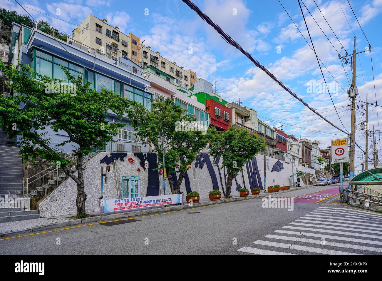 Unique buildings on sloped retaining walls in Busan, featuring vibrant ...