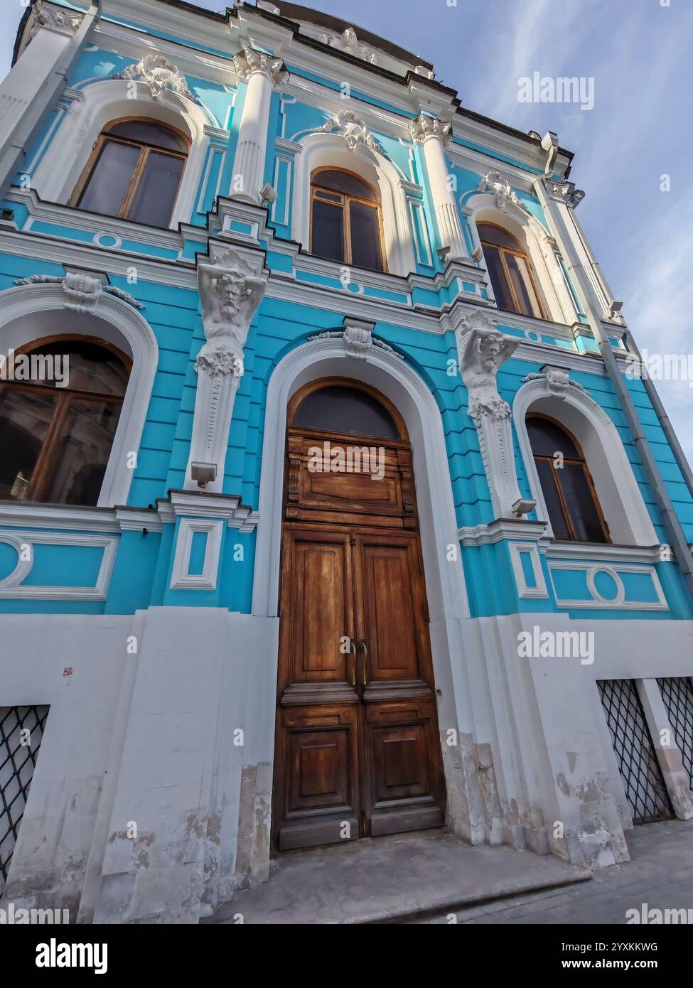 The facade of a classical-style building painted in vivid blue ...