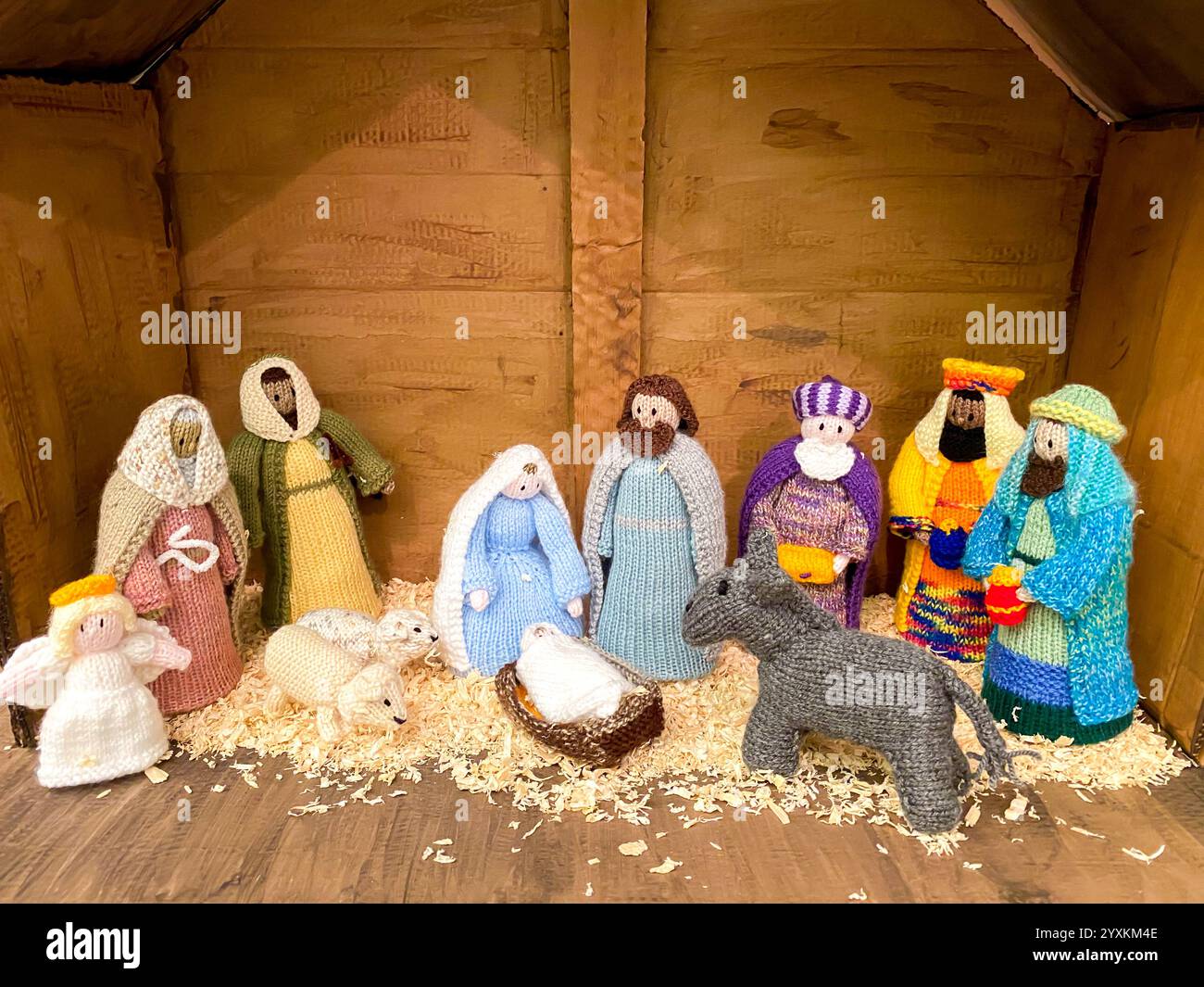A crocheted Christmas nativity scene depicting the birth of Jesus in a ...